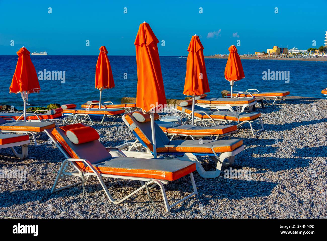Sunbeds and umbrellas at a beach in Rhodes town in Greece Stock Photo ...