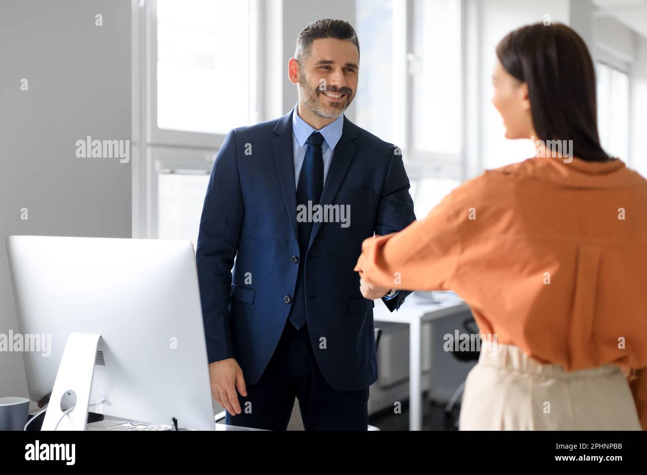 Happy male personnel manager and female job applicant shaking hands ...