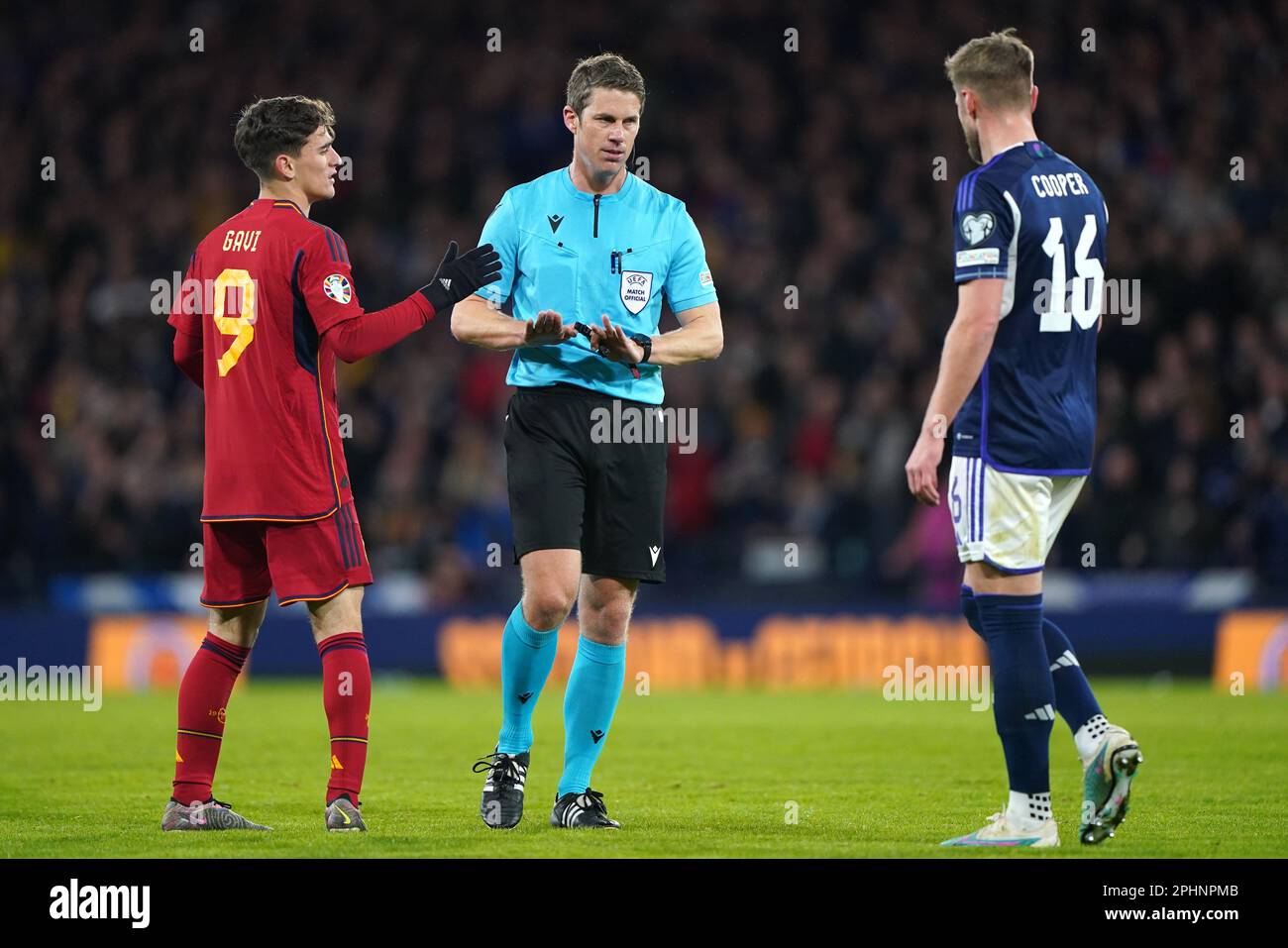 Referee Sandro Scharer speaks to Scotland's Liam Cooper during the UEFA ...