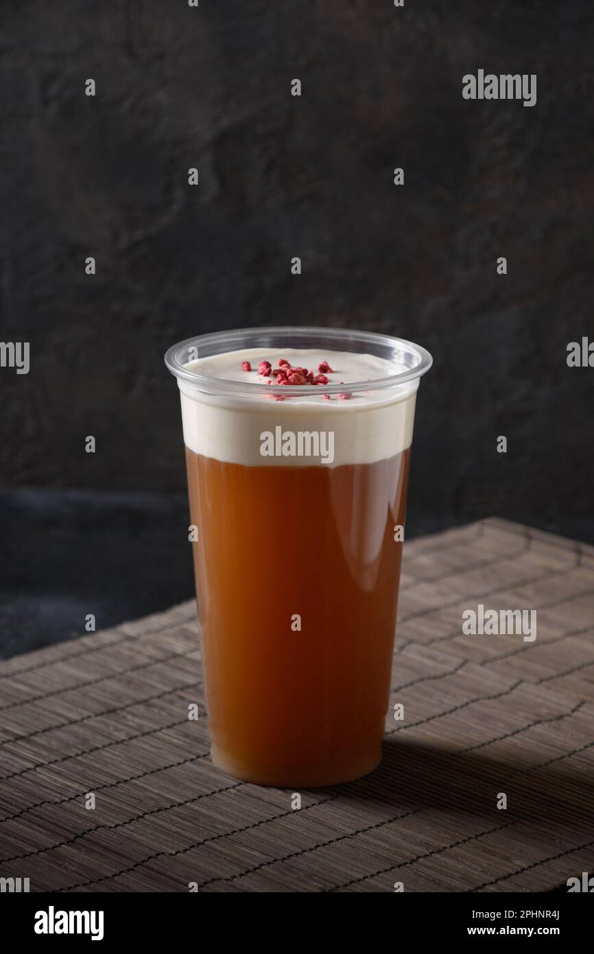 Chinese cheese tea in plastic cup with whipped cream cheese topped ...