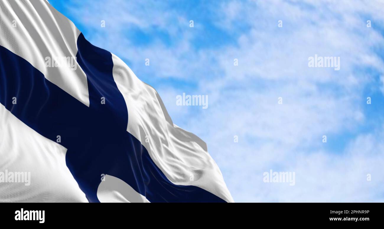The national flag of Finland waving in the wind on a clear day. Blue ...
