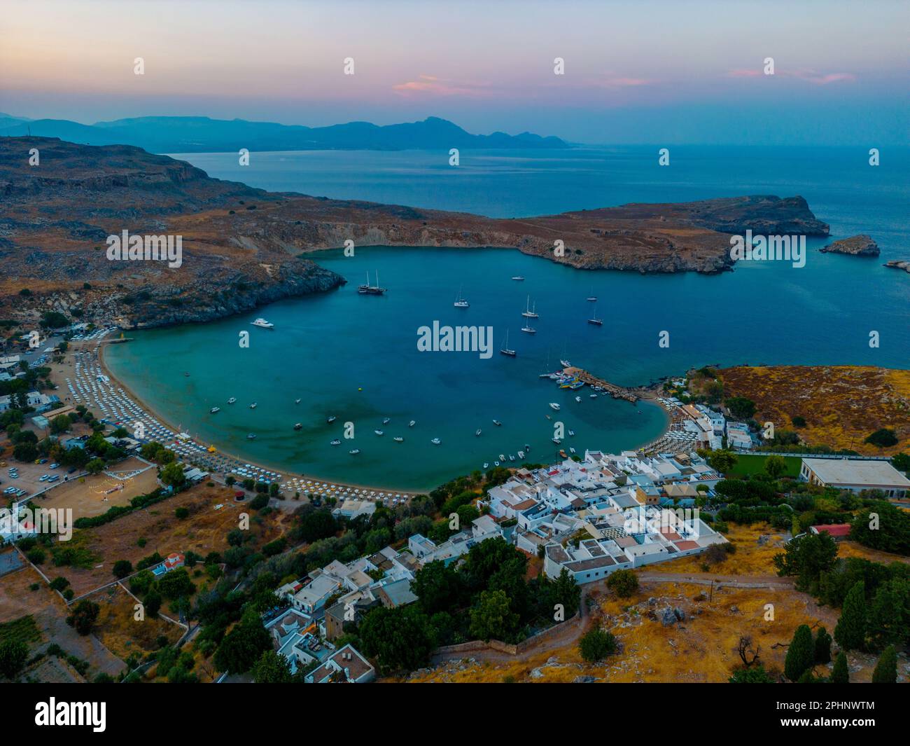 Sunset panorama view of Lindos beach at Greek island Rhodes Stock Photo ...