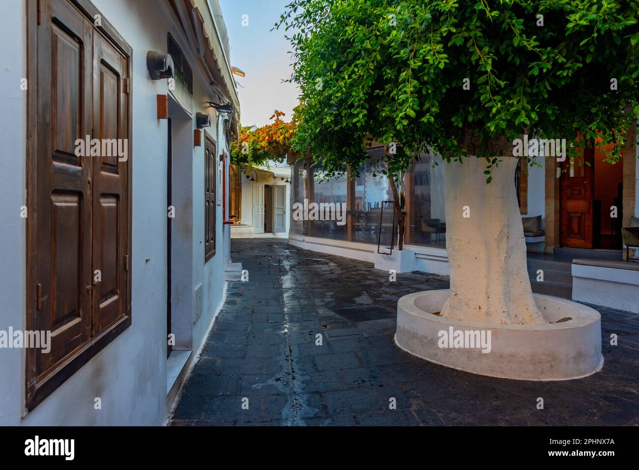 Sunset view of white streets of Greek town Lindos at Rhodes island ...
