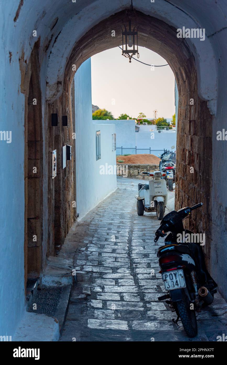 Sunset view of white streets of Greek town Lindos at Rhodes island ...