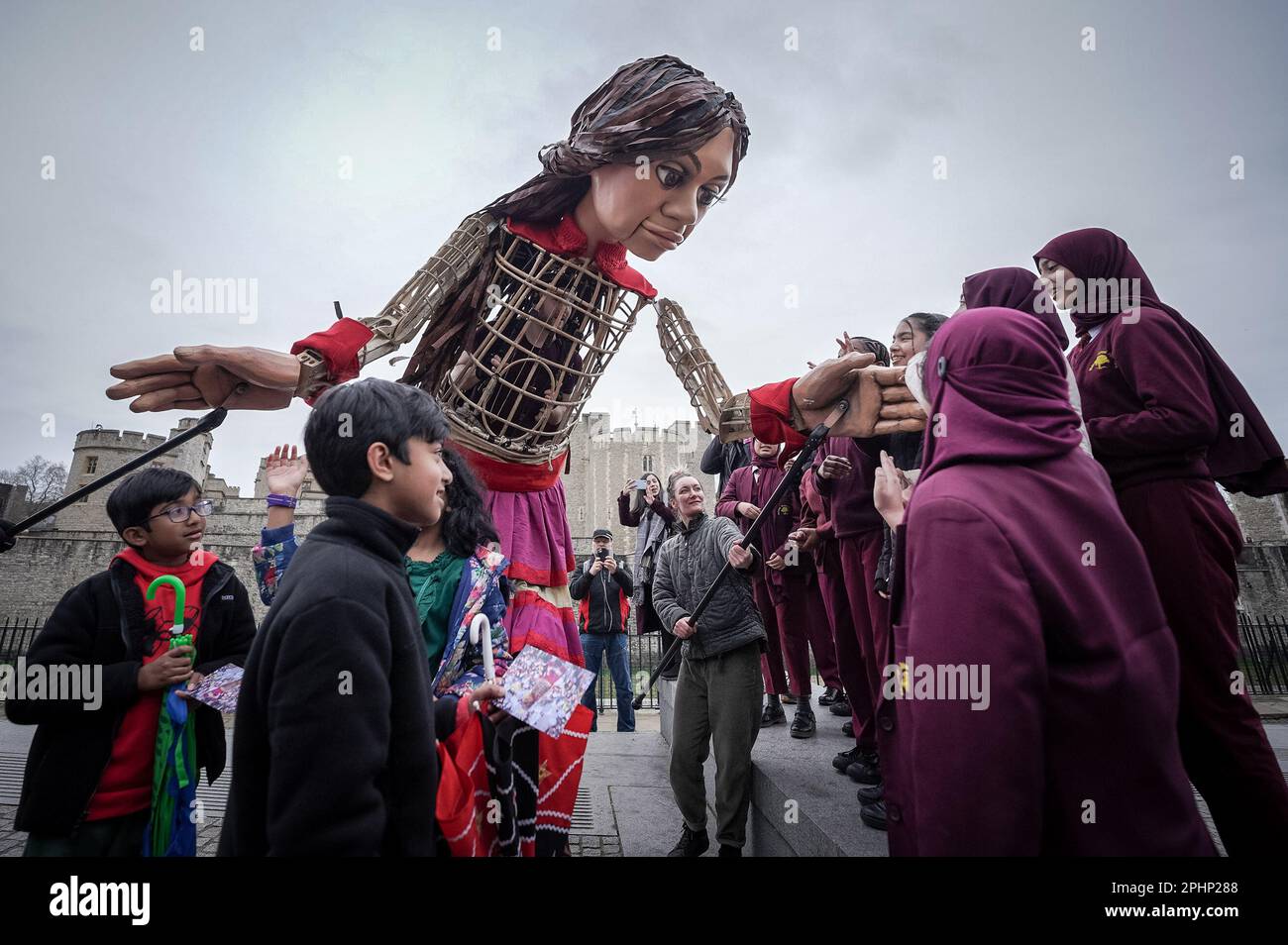 London, UK. 29th March, 2023. Little Amal arrives at Tower Hill and ...