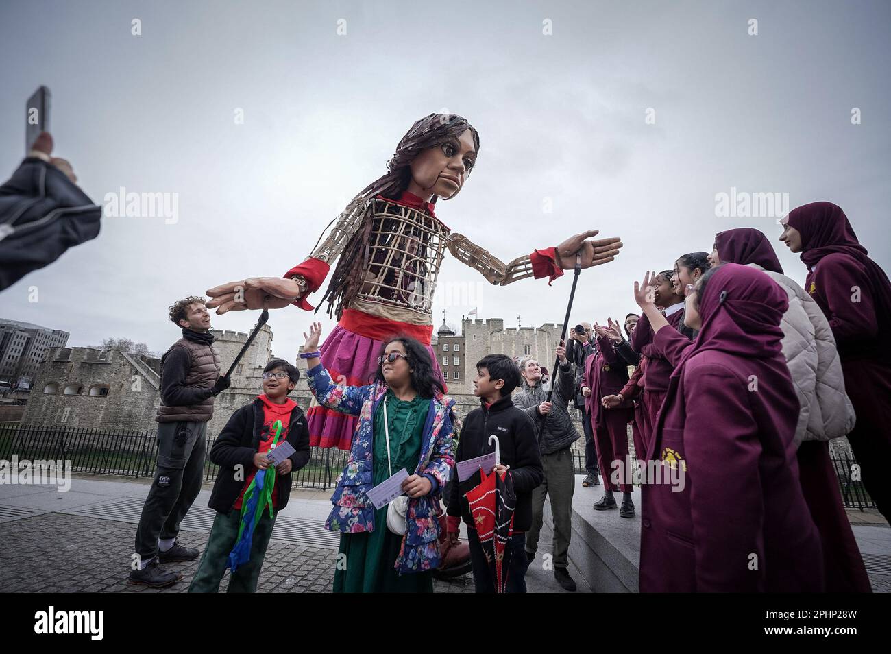 London, UK. 29th March, 2023. Little Amal arrives at Tower Hill and ...