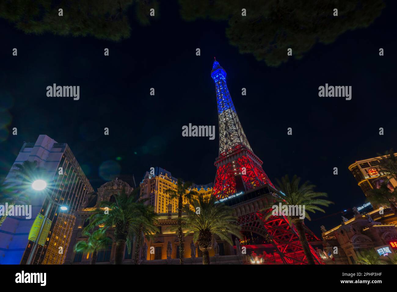 Gorgeous night view of tops of Strip's hotel buildings, with luminous blue-white-red light of ...