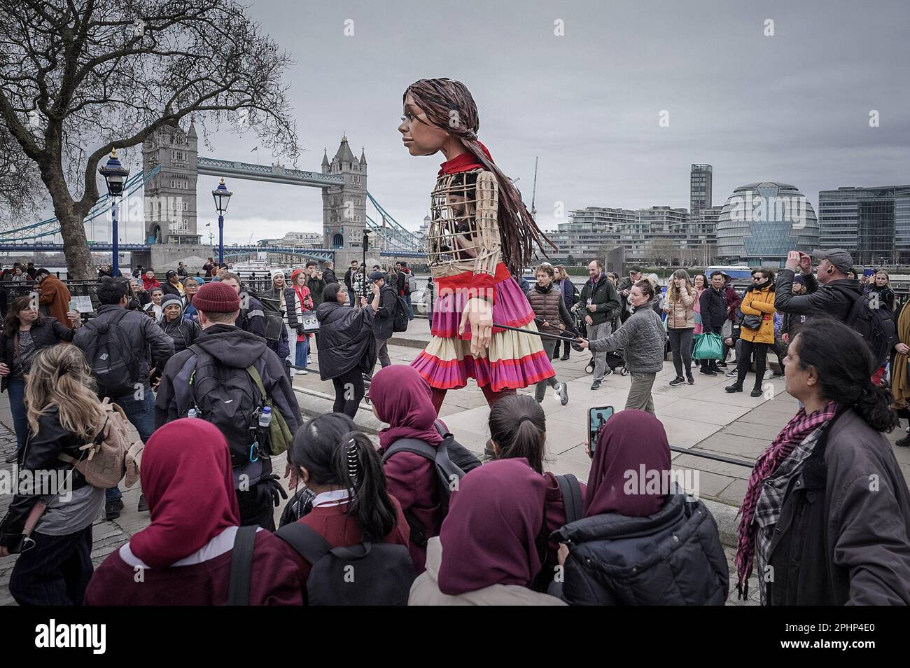 London, UK. 29th March, 2023. Little Amal arrives at Tower Hill. Amal ...