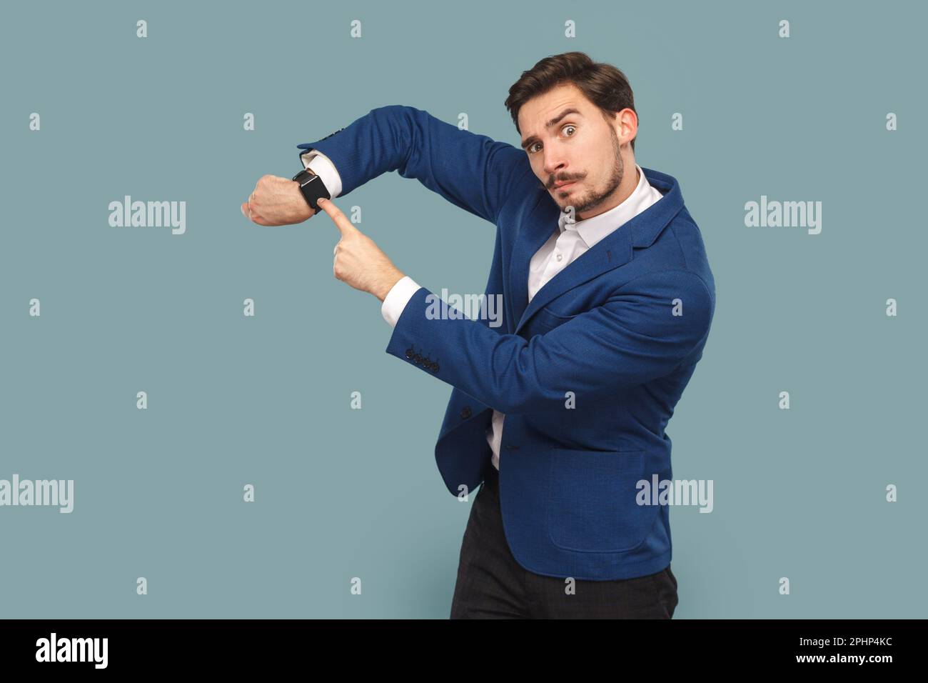 Portrait of serious assertive man with mustache standing pointing at ...