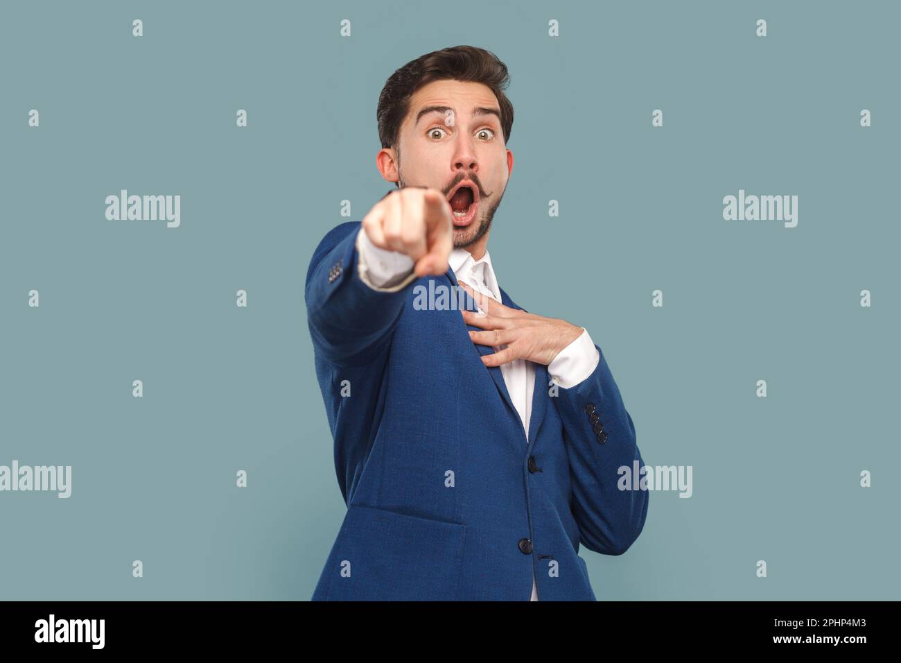 Astonished shocked man with mustache standing pointing finger to camera ...