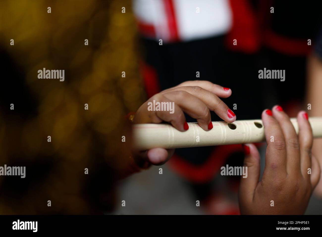 Kathmandu, Nepal. 29th Mar, 2023. A girl plays the flute during the ...