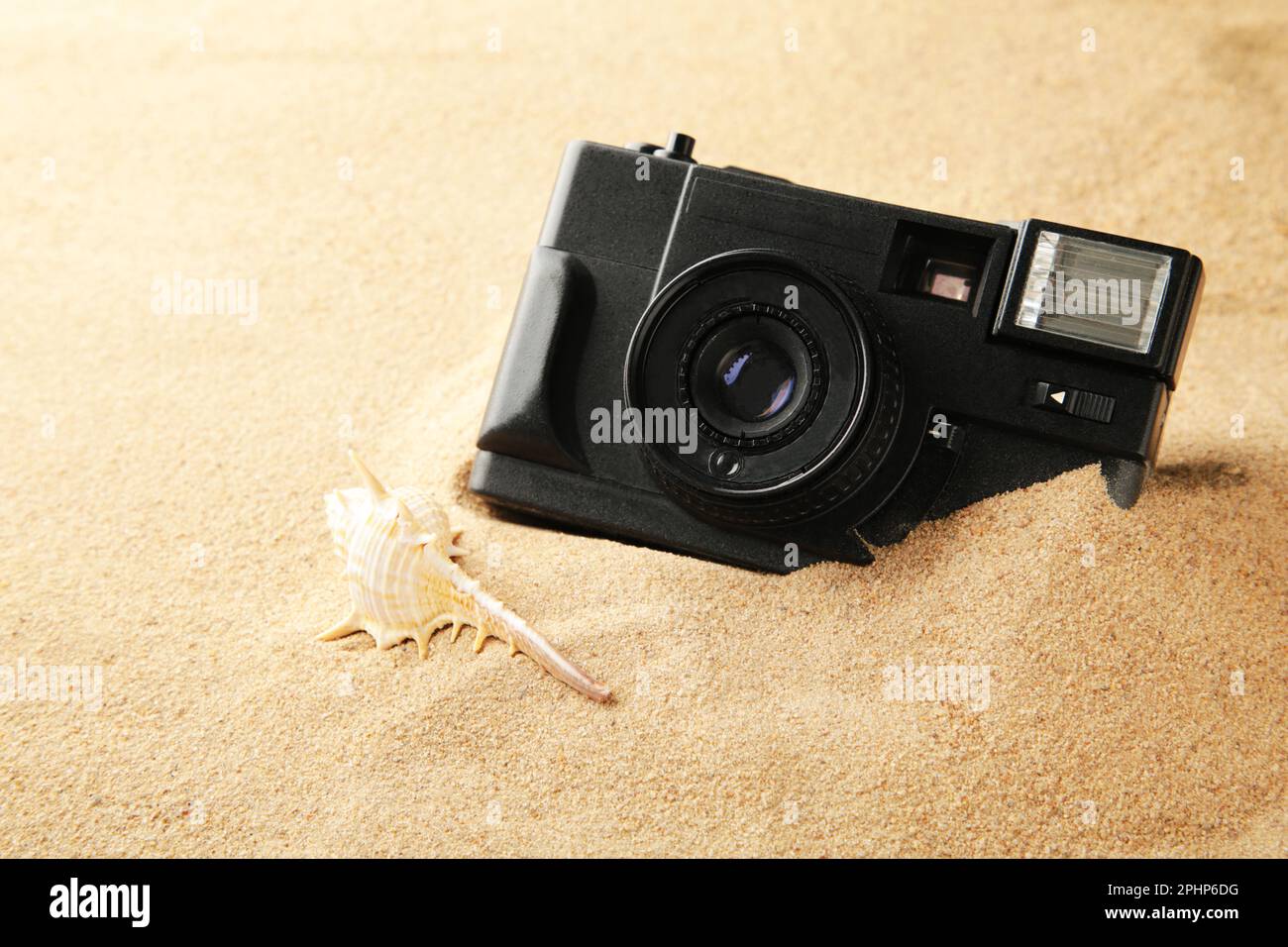 Retro camera in the sand with seashell on a beach. Top view Stock Photo ...