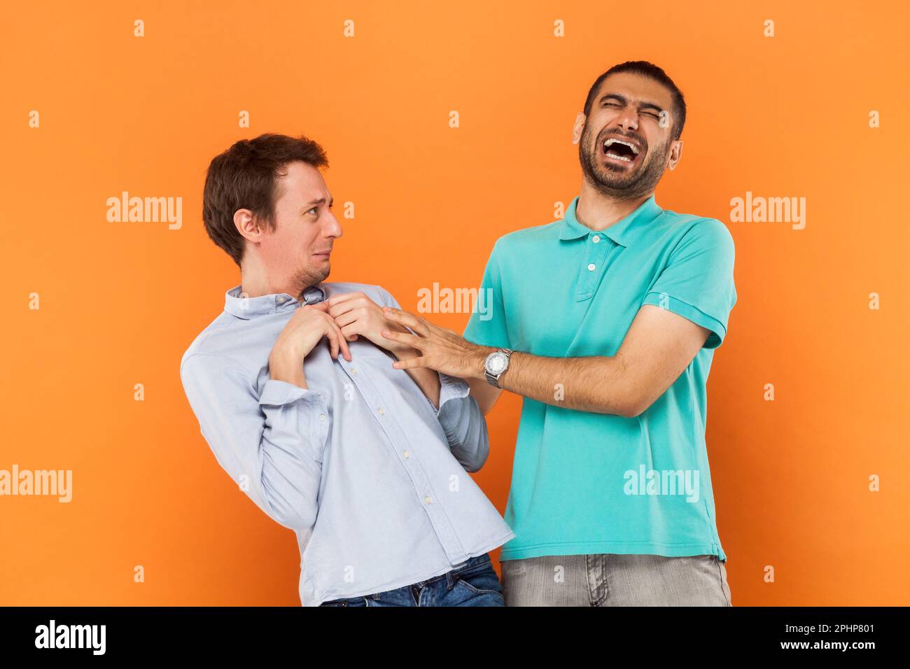 Portrait of two handsome young adult men posing together, friend ...