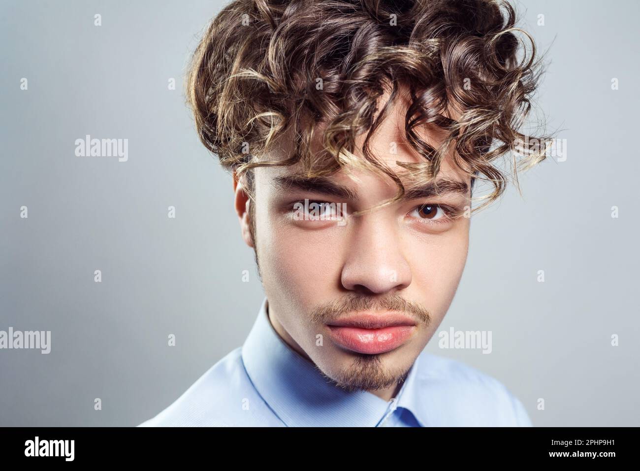 Portrait of handsome man with mustache and beard with curly hairstyle ...