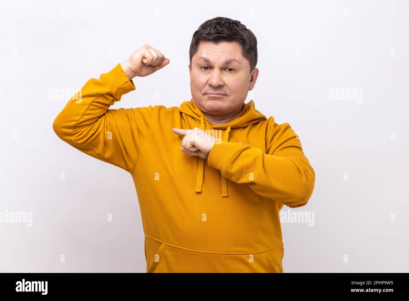 I am strong. Portrait of proud man pointing at raised hand ...