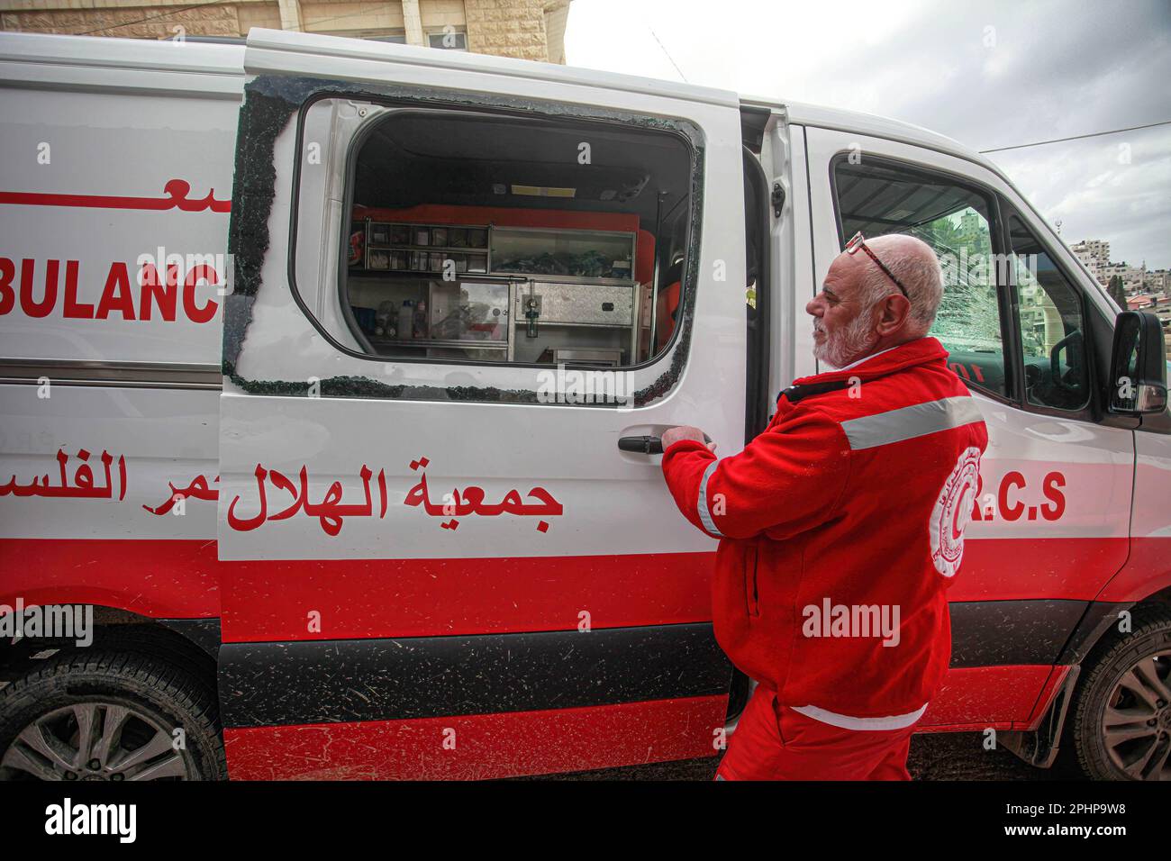 A Palestinian paramedic inspects a destroyed Red Crescent ambulance ...