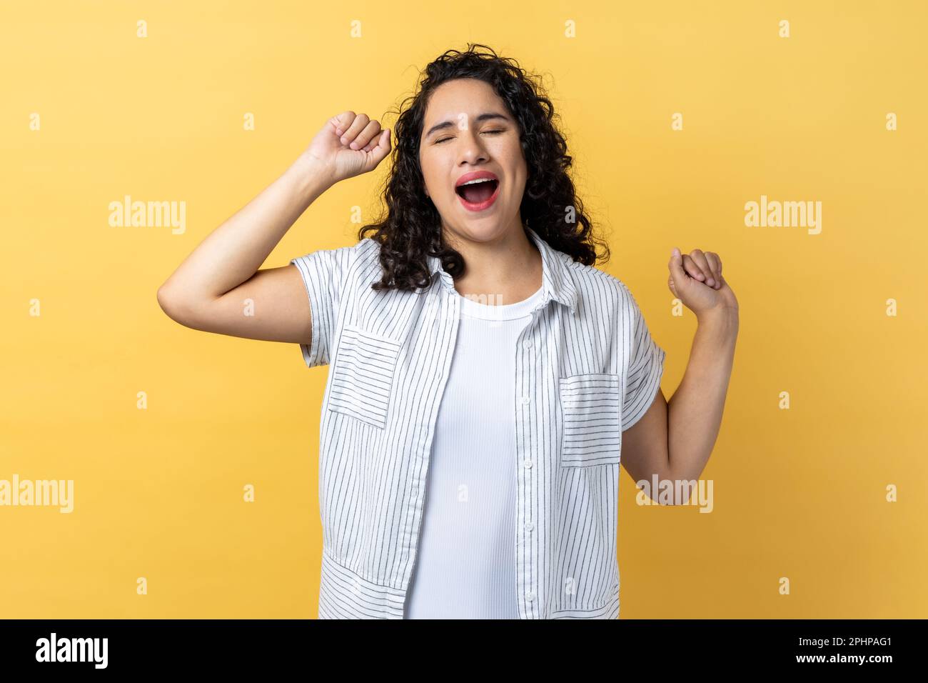 Portrait of tired sleepy beautiful woman with dark wavy hair yawning ...