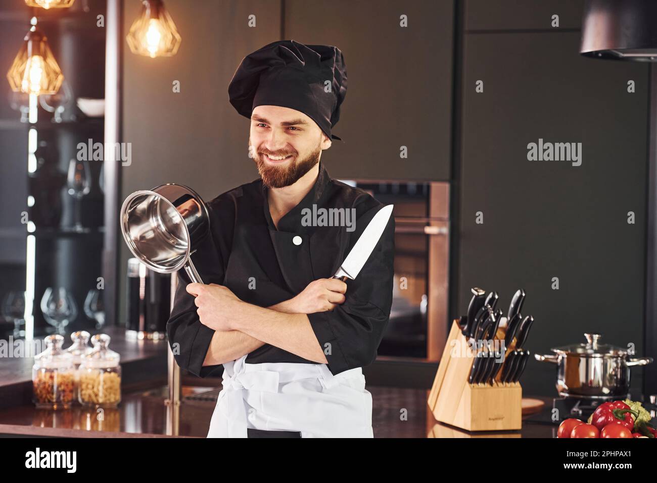 Portrait of professional young chef cook in uniform that posing for ...