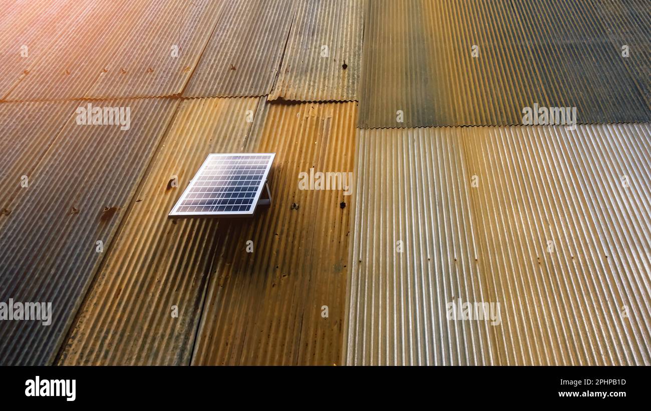 Solar panel attached on old zinc wall. Electric solar panel on the ...