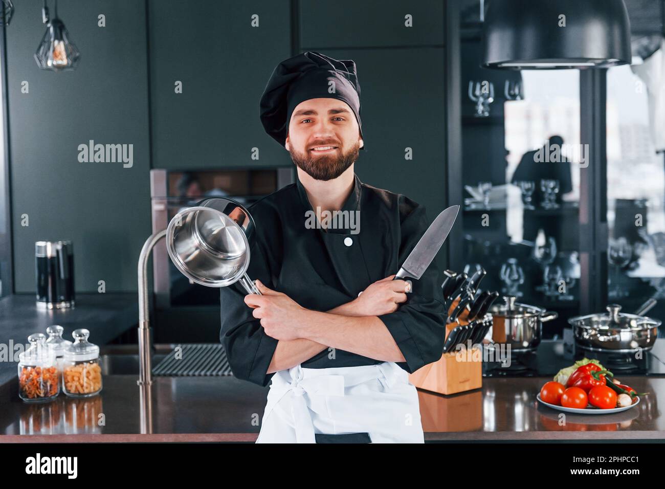 Portrait of professional young chef cook in uniform that posing for ...