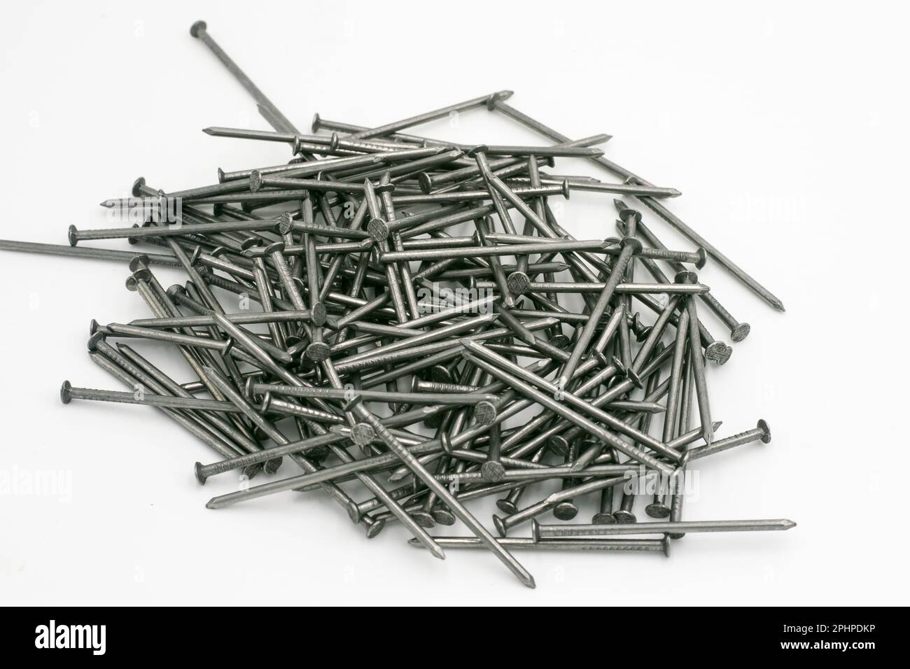 Metal nails neatly stacked on a white background Stock Photo - Alamy