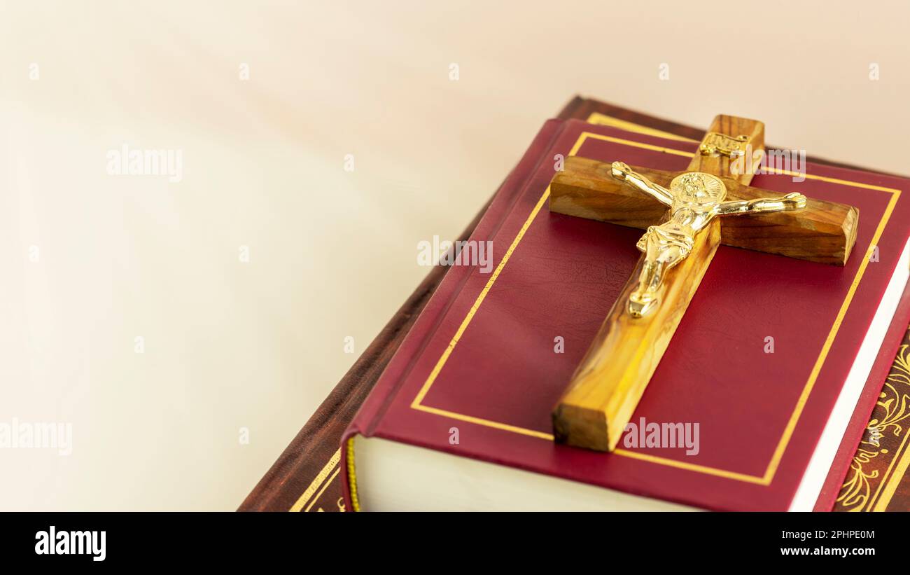 Religion composition with wooden crucifix with closed red Christian ...