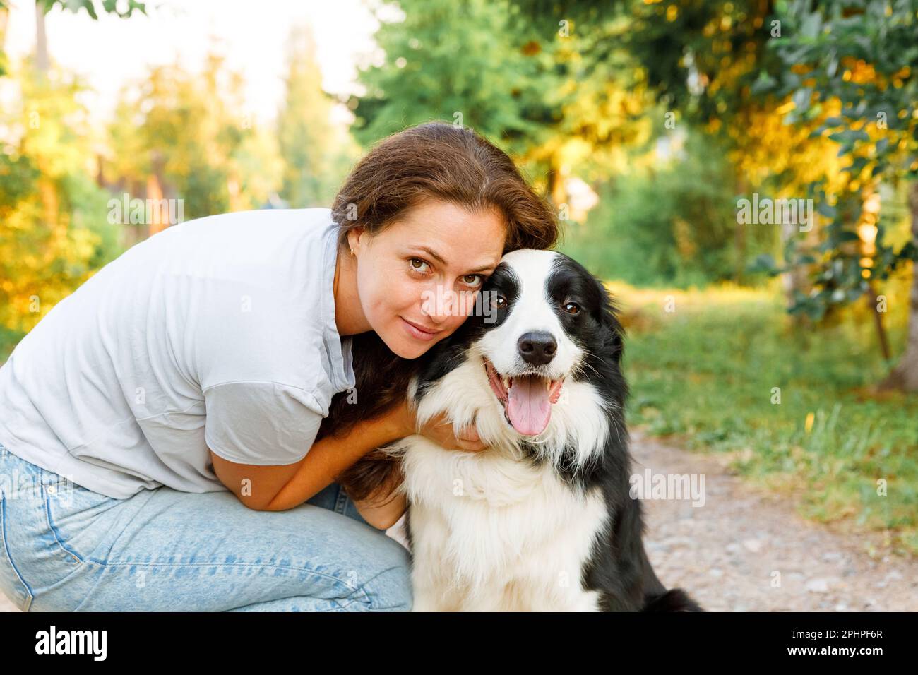 Young attractive woman playing with cute puppy dog border collie on ...