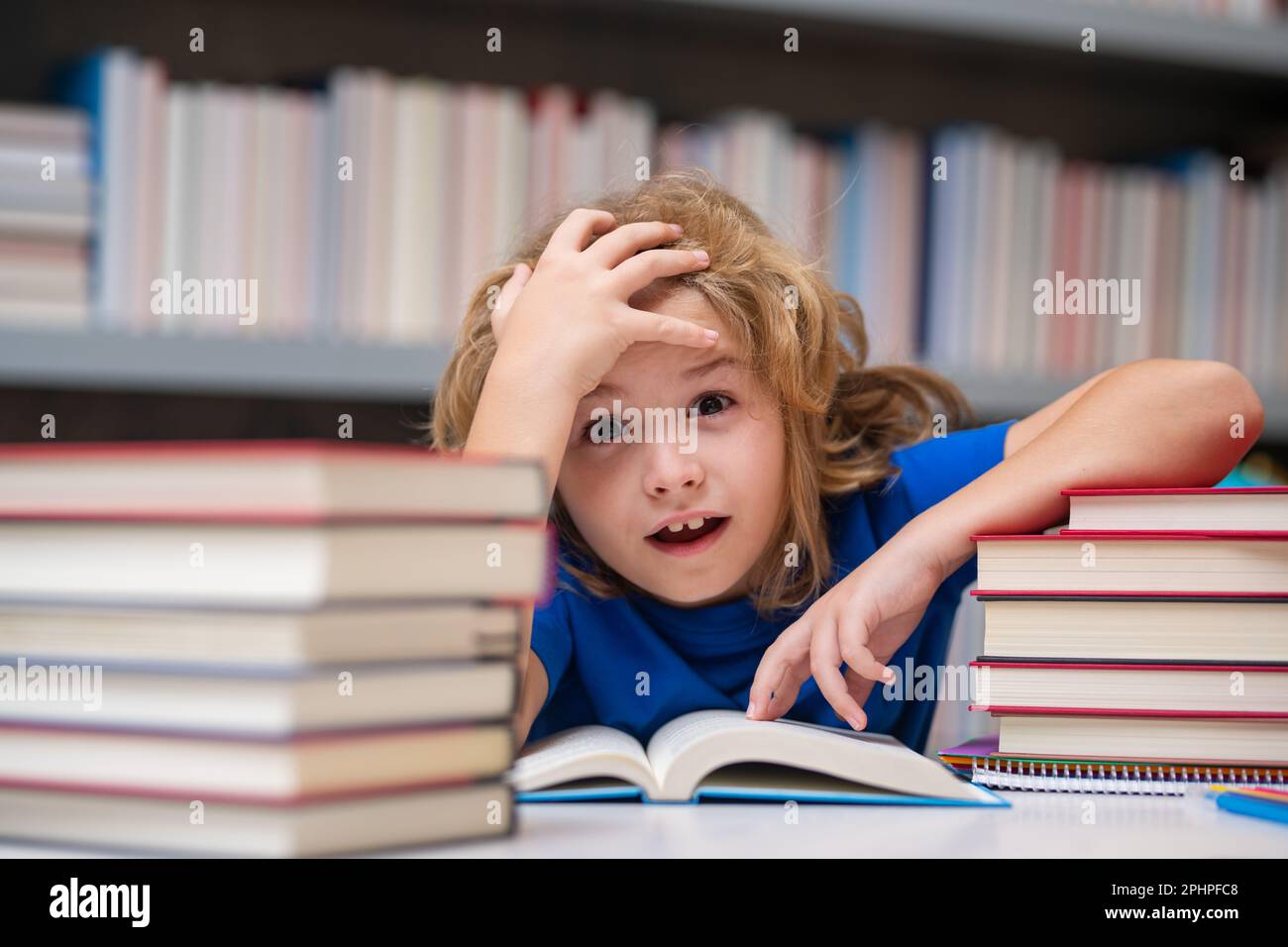 Nerd pupil. School child pupil reading book at school. Kid doing ...