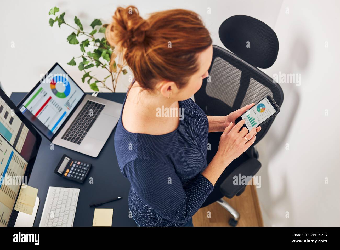 Businesswoman working with financial data on charts and tables on ...