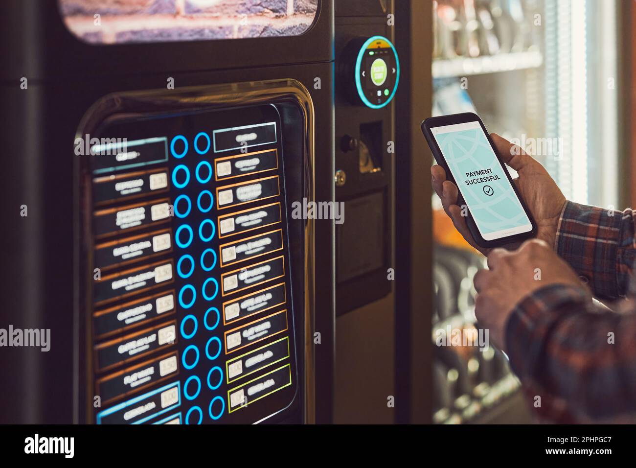 Consumer paying for product at vending machine using contactless method of payment with mobile ...