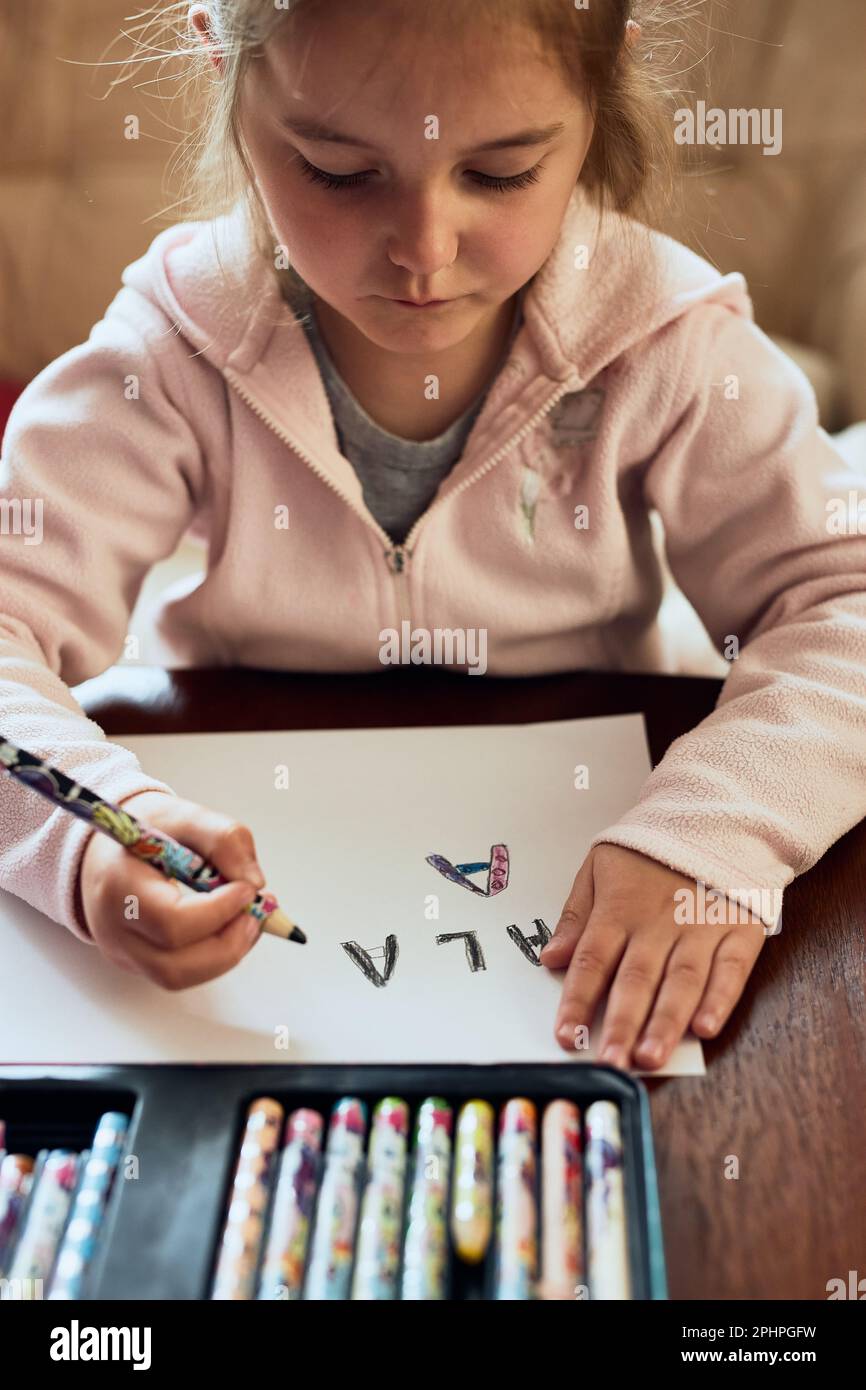 Little girl preschooler learning to write letters at home. Kid using ...