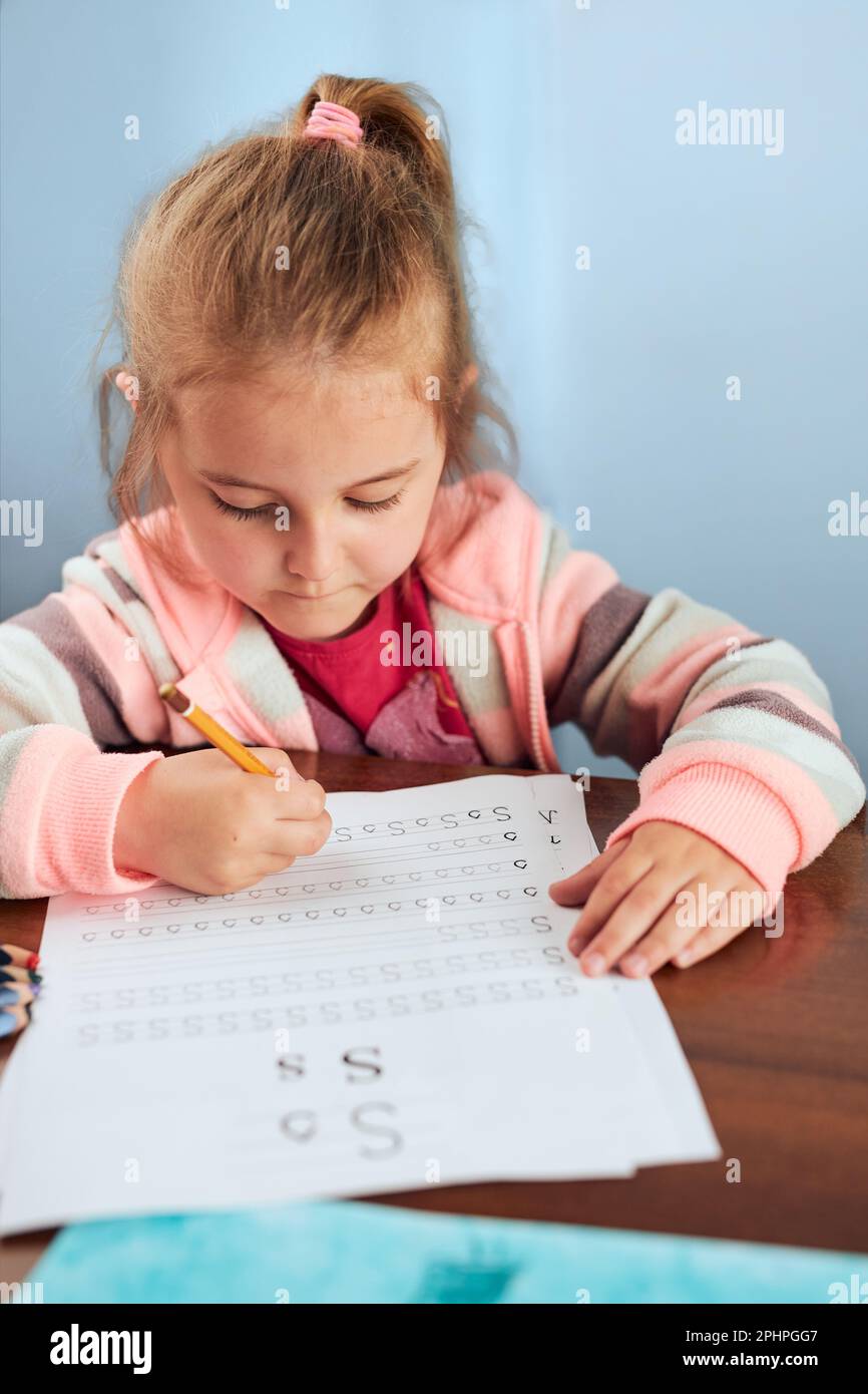 Little girl preschooler learning to write letters at school. Kid ...