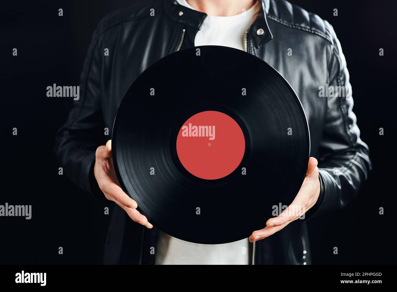 Man holding vinyl record. Vintage music style. Rock style male wearing ...