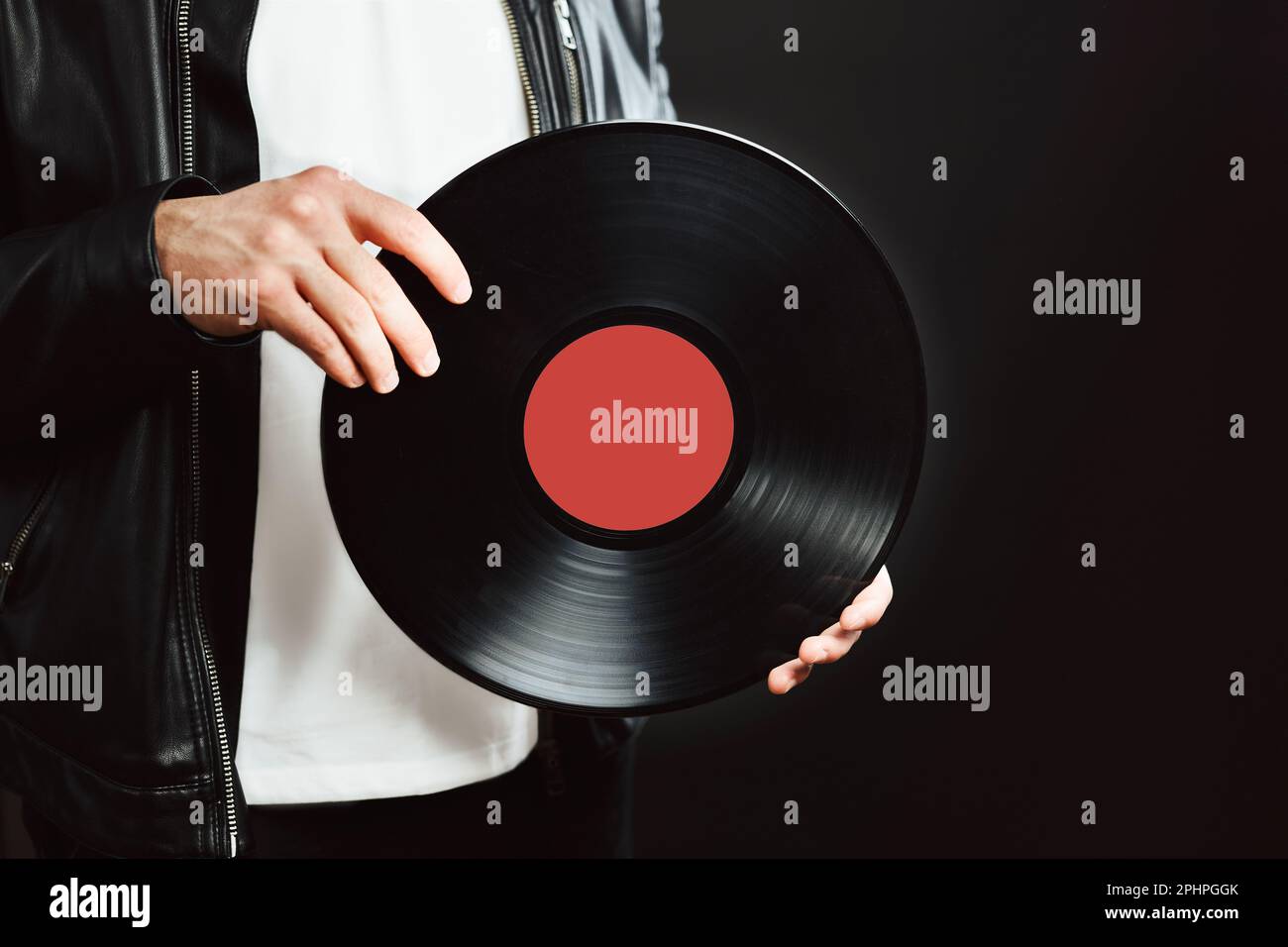 Man with vinyl record. Vintage music style. Rock style. Male wearing ...
