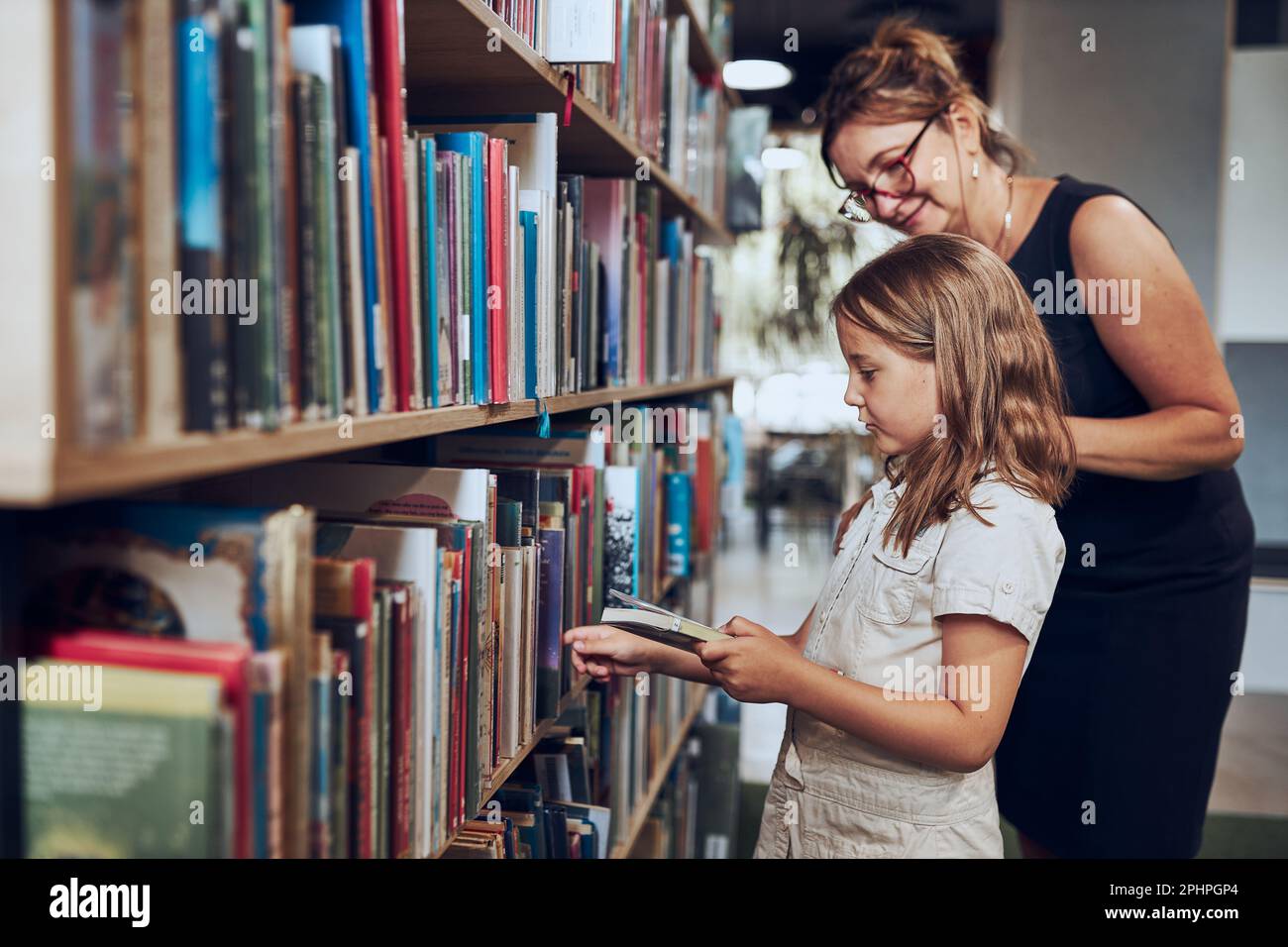 Girl teacher library hi-res stock photography and images - Alamy