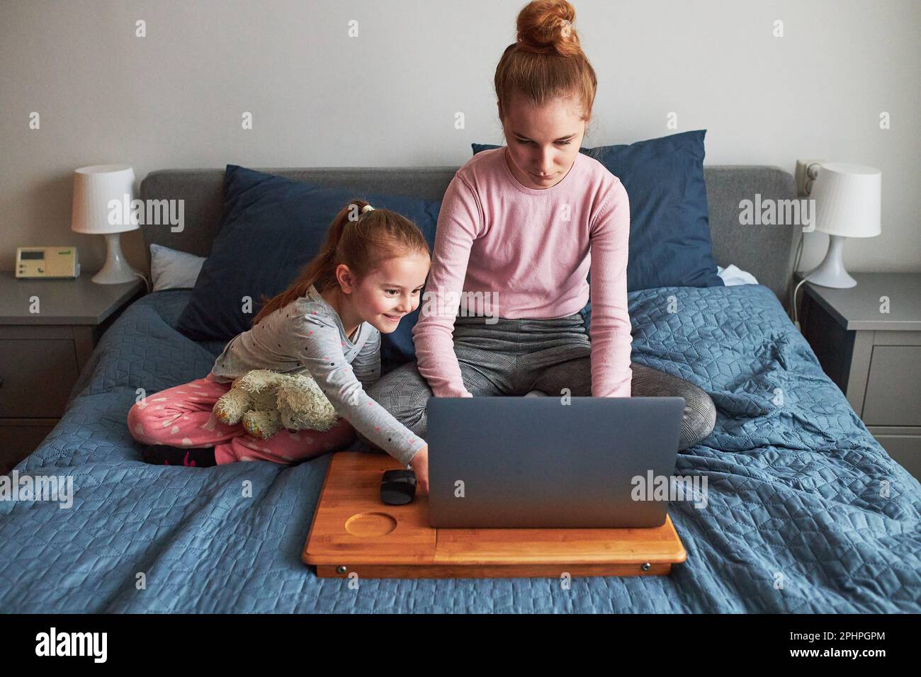 Teenage girl working on school tests homework remotely on her laptop ...