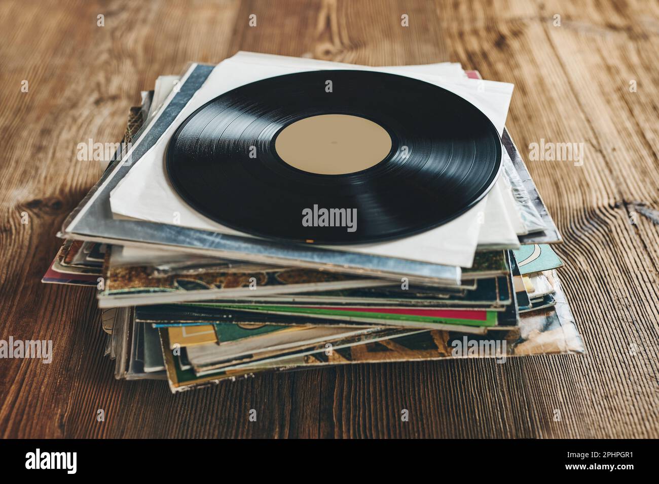 Stack of vinyl records. Listening to music from record. Playing music ...