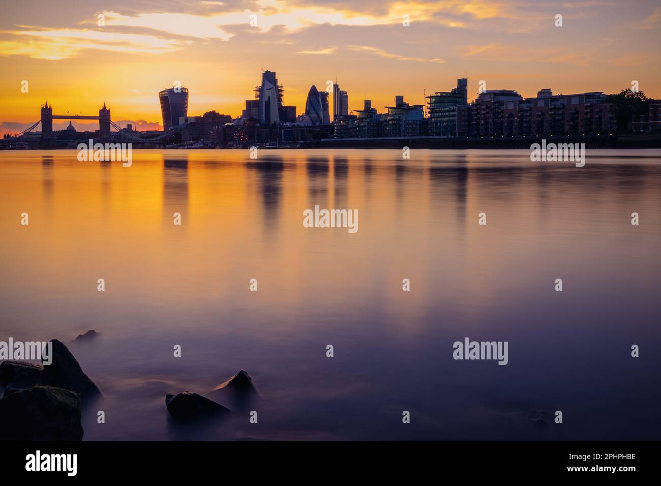 Long exposure, silhouette of London cityscape with the River Thames ...