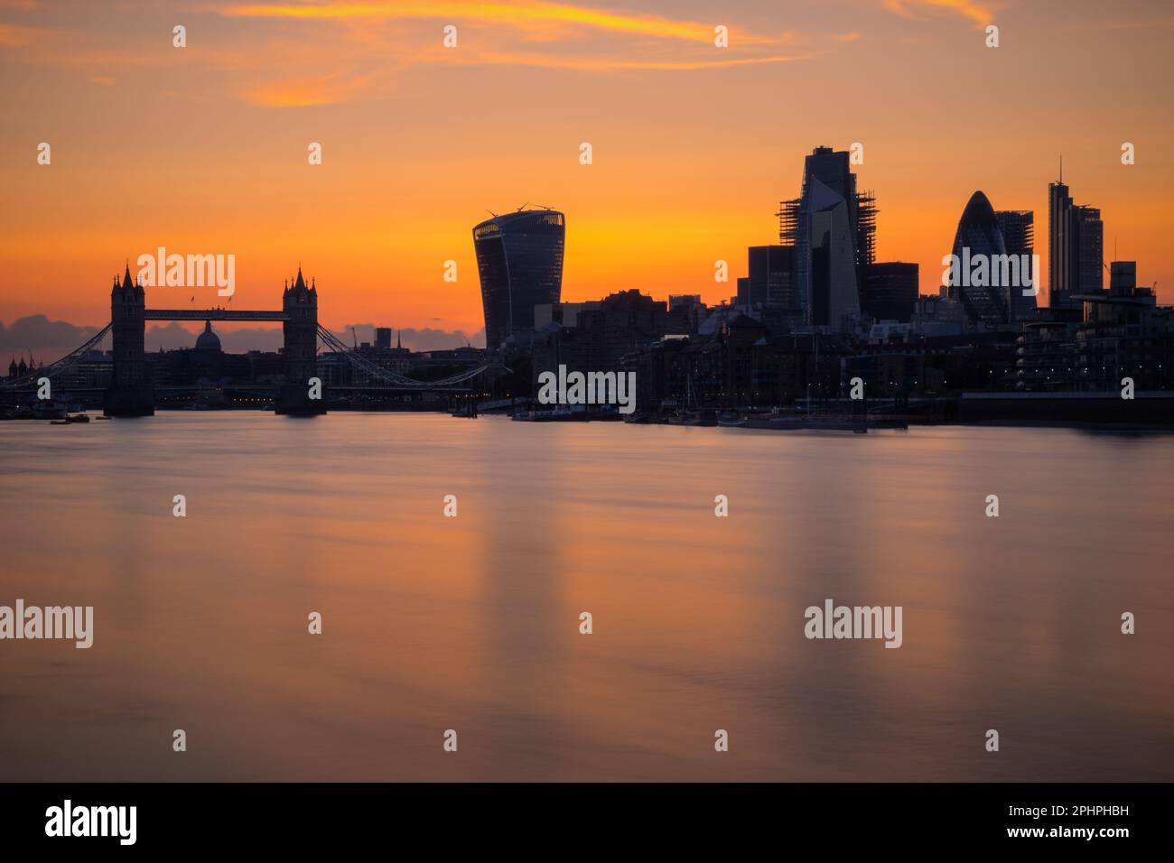 Long exposure, silhouette of London cityscape with the River Thames ...