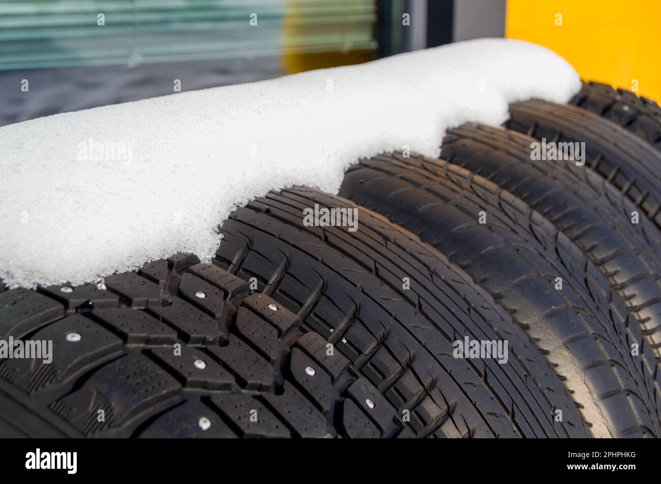 Winter tires covered by snow. Studded and friction tires Stock Photo ...