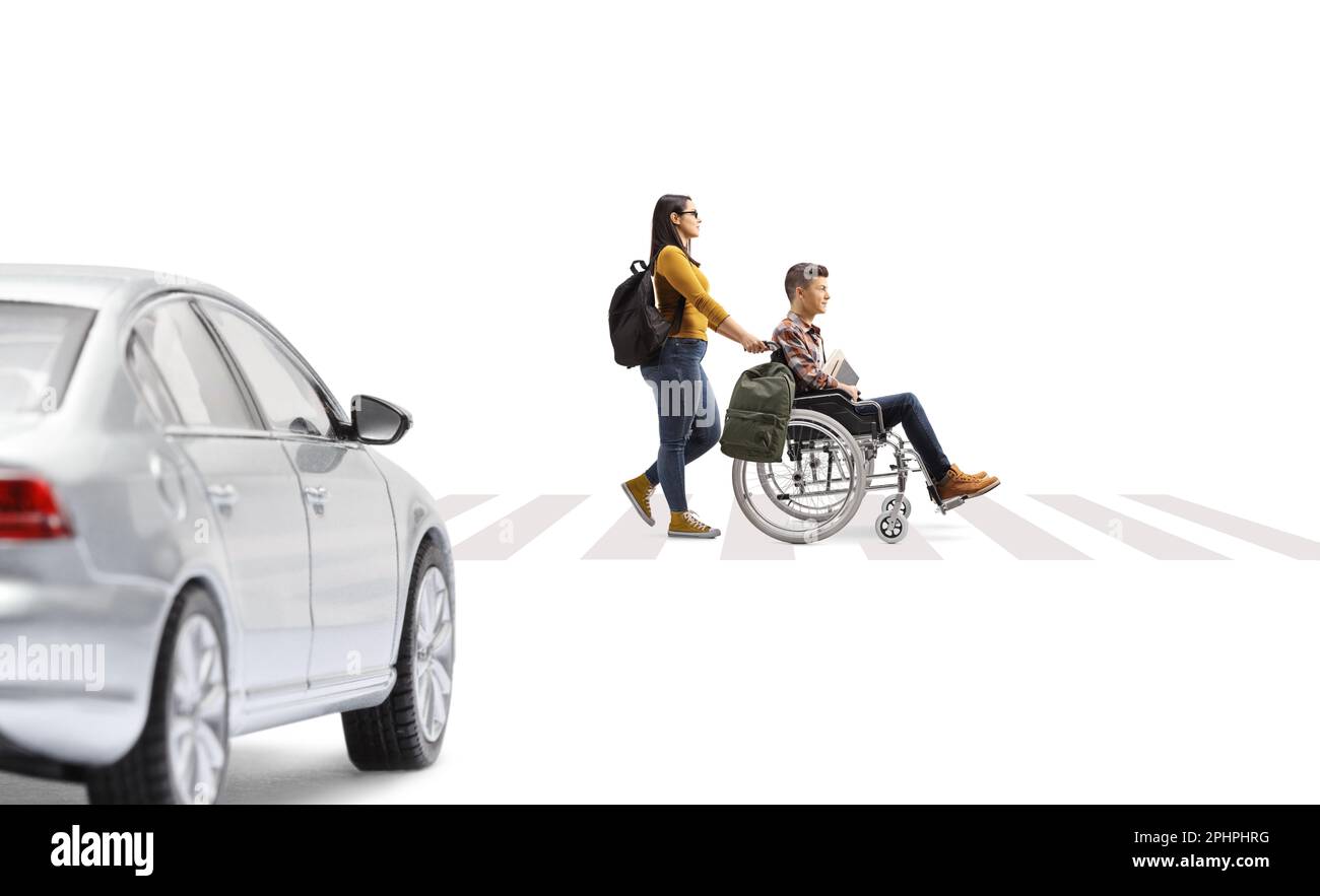 Female student pushing a friend in a wheelchair at a pedestrian ...