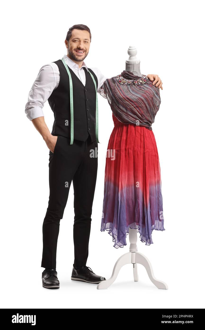 Full length portrait of a tailor posing with a dress on a doll ...