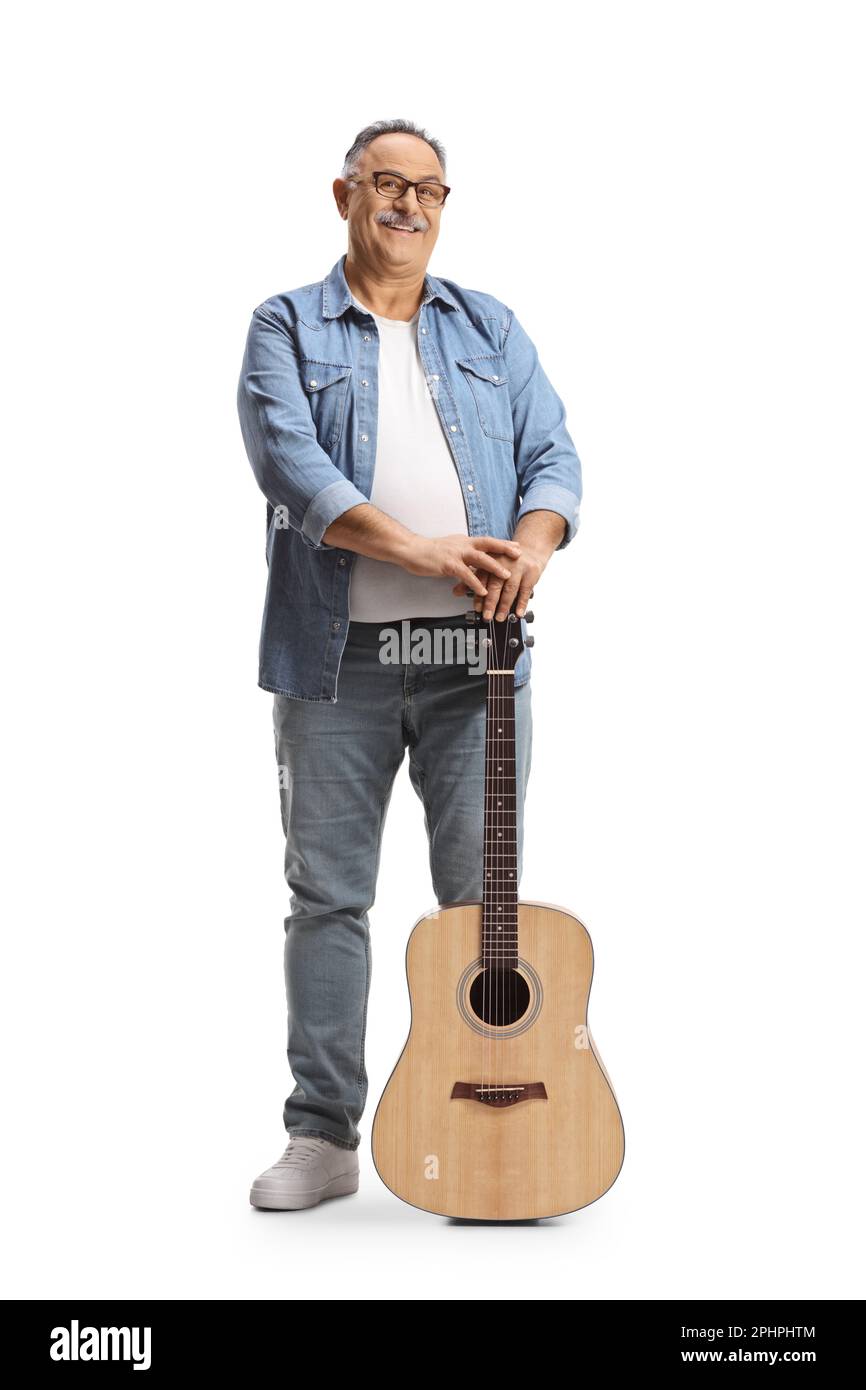 Full length portrait of a mature man standing with an acoustic guitar ...