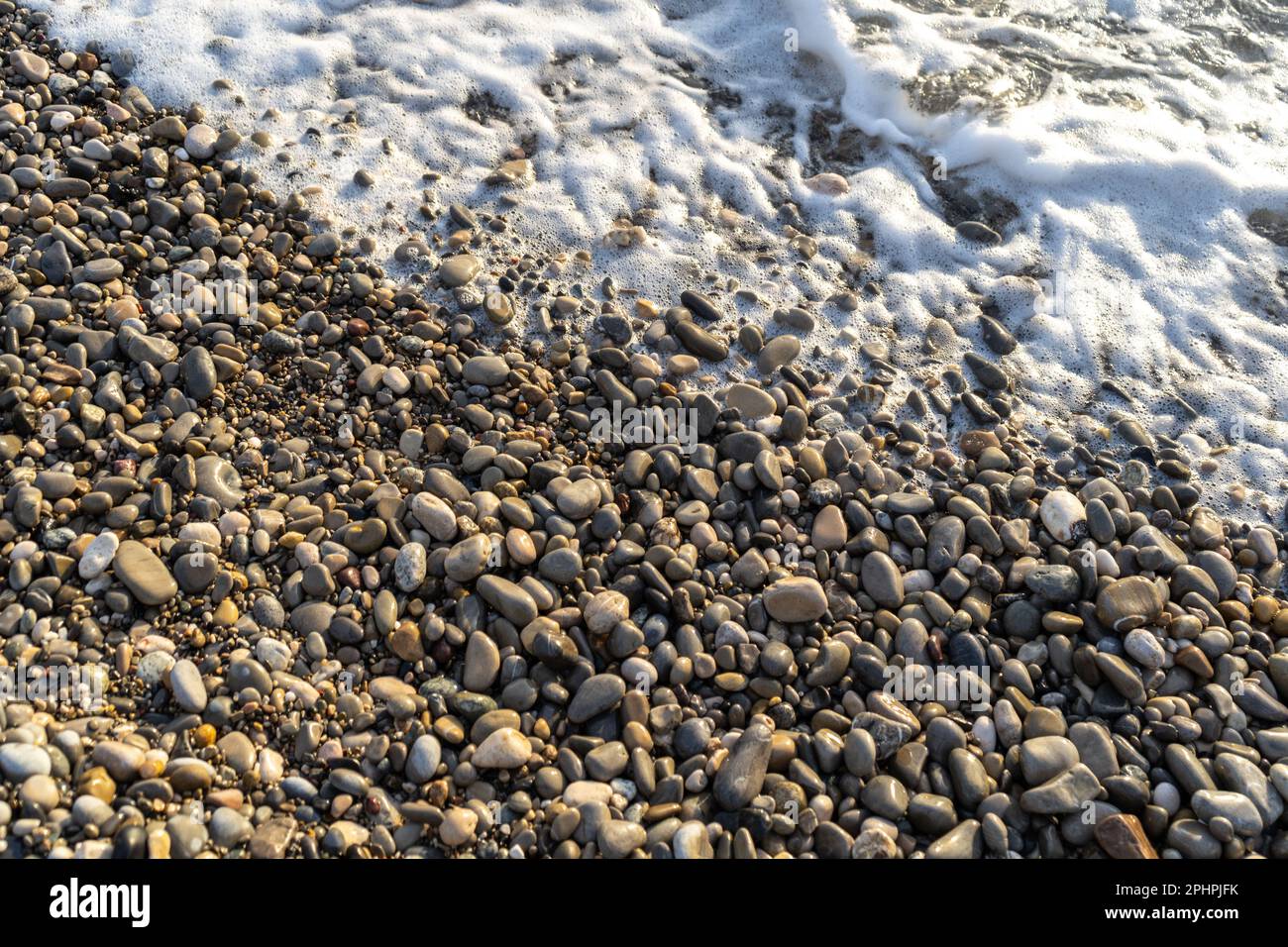 Sea waves on pebble beach texture background. Transparent ocean water ...