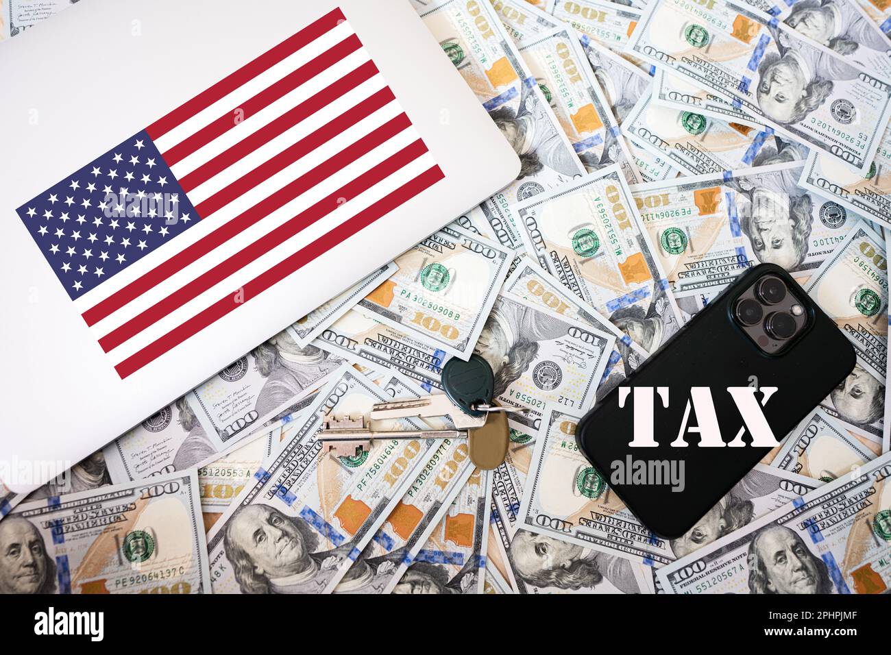 Tax concept. USA flag, dollar money with keys, laptop and phone ...