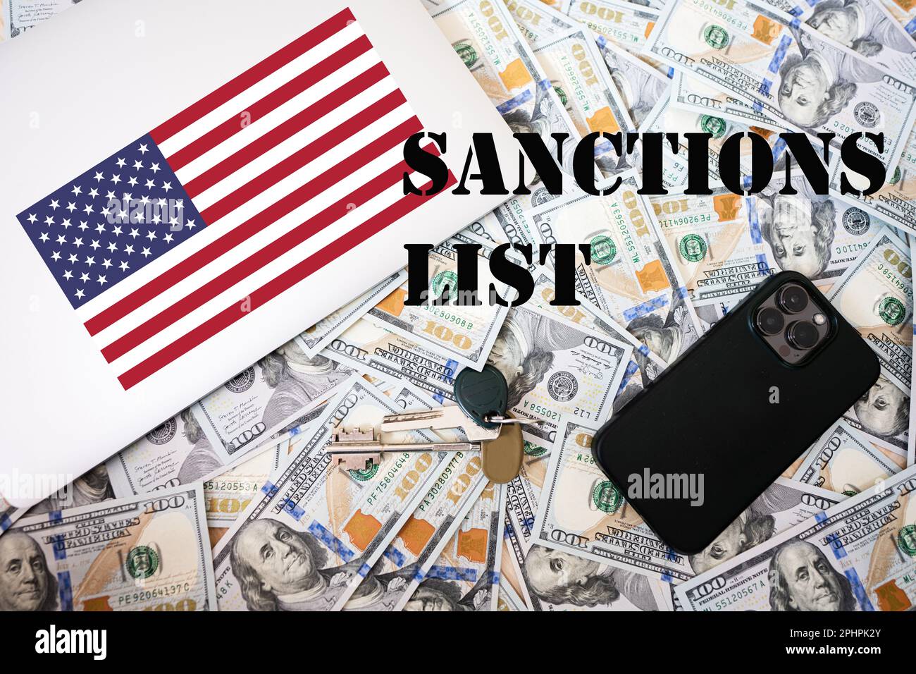 Sanctions list concept. USA flag, dollar money with keys, laptop and ...