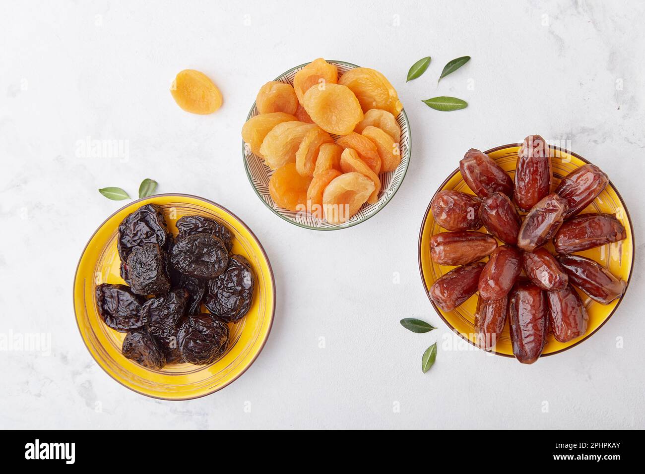 Healthy snacks - prunes, dried apricots, dates top view Stock Photo - Alamy