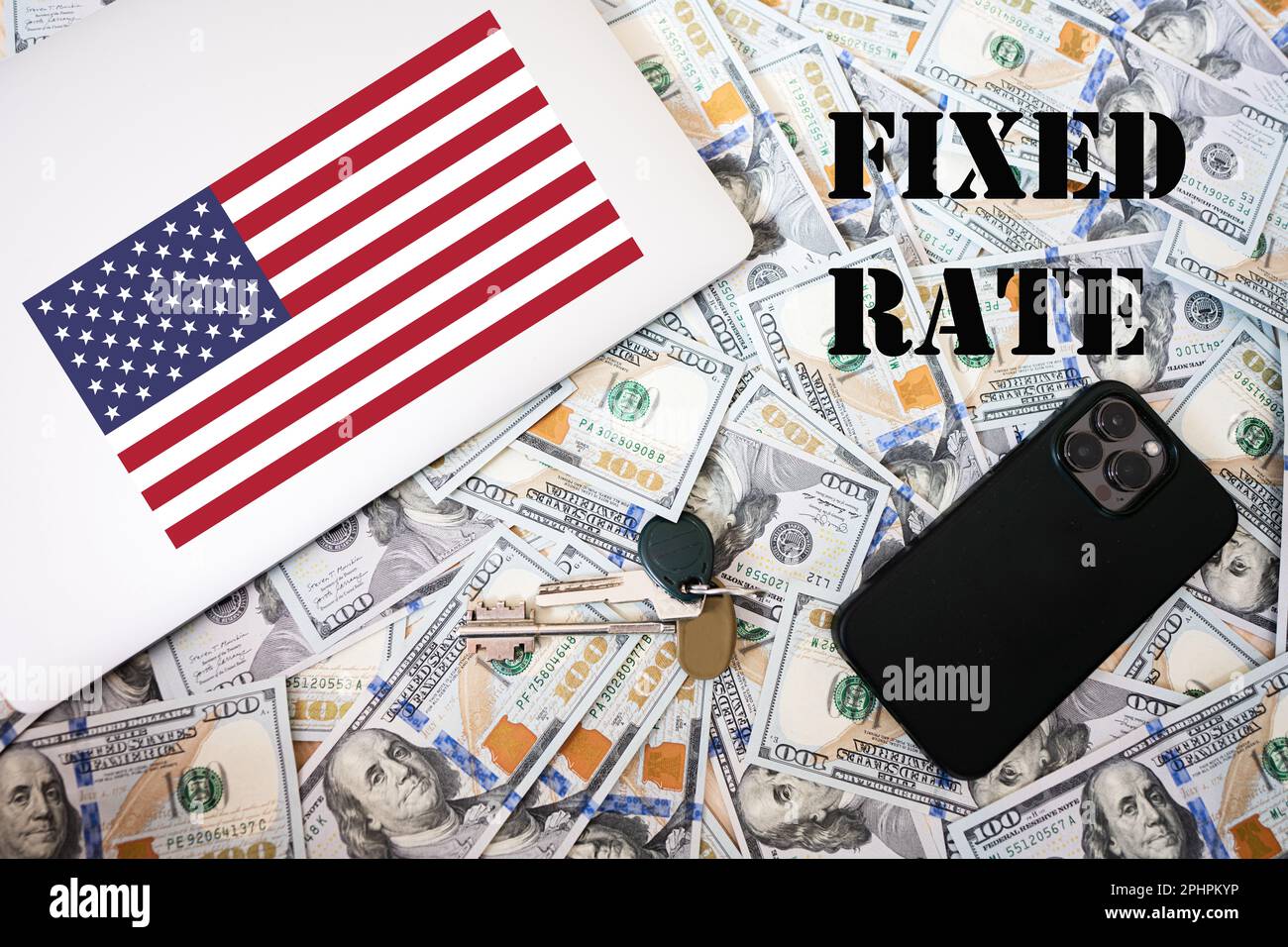 Fixed rate concept. USA flag, dollar money with keys, laptop and phone ...