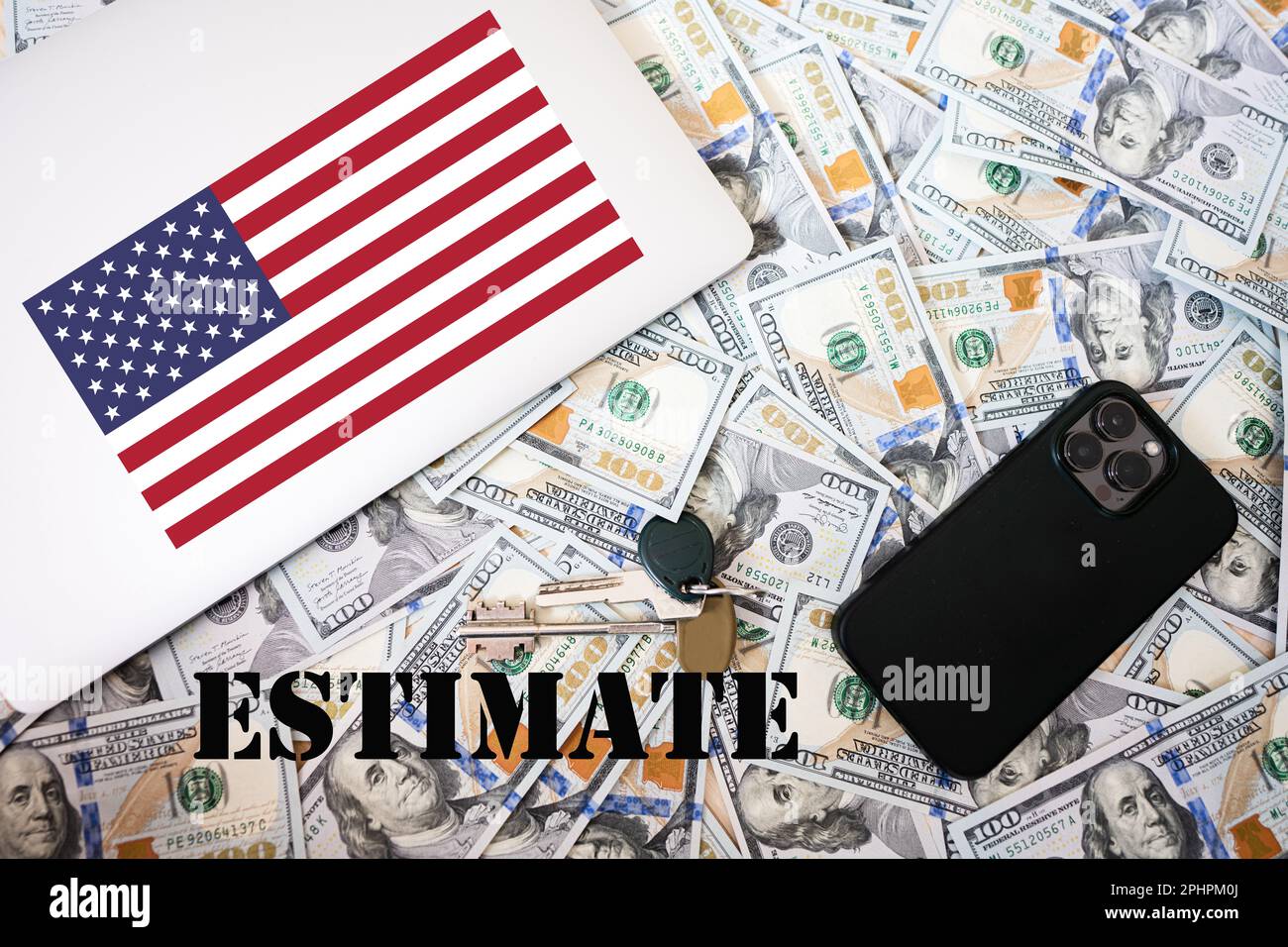 Estimate concept. USA flag, dollar money with keys, laptop and phone ...