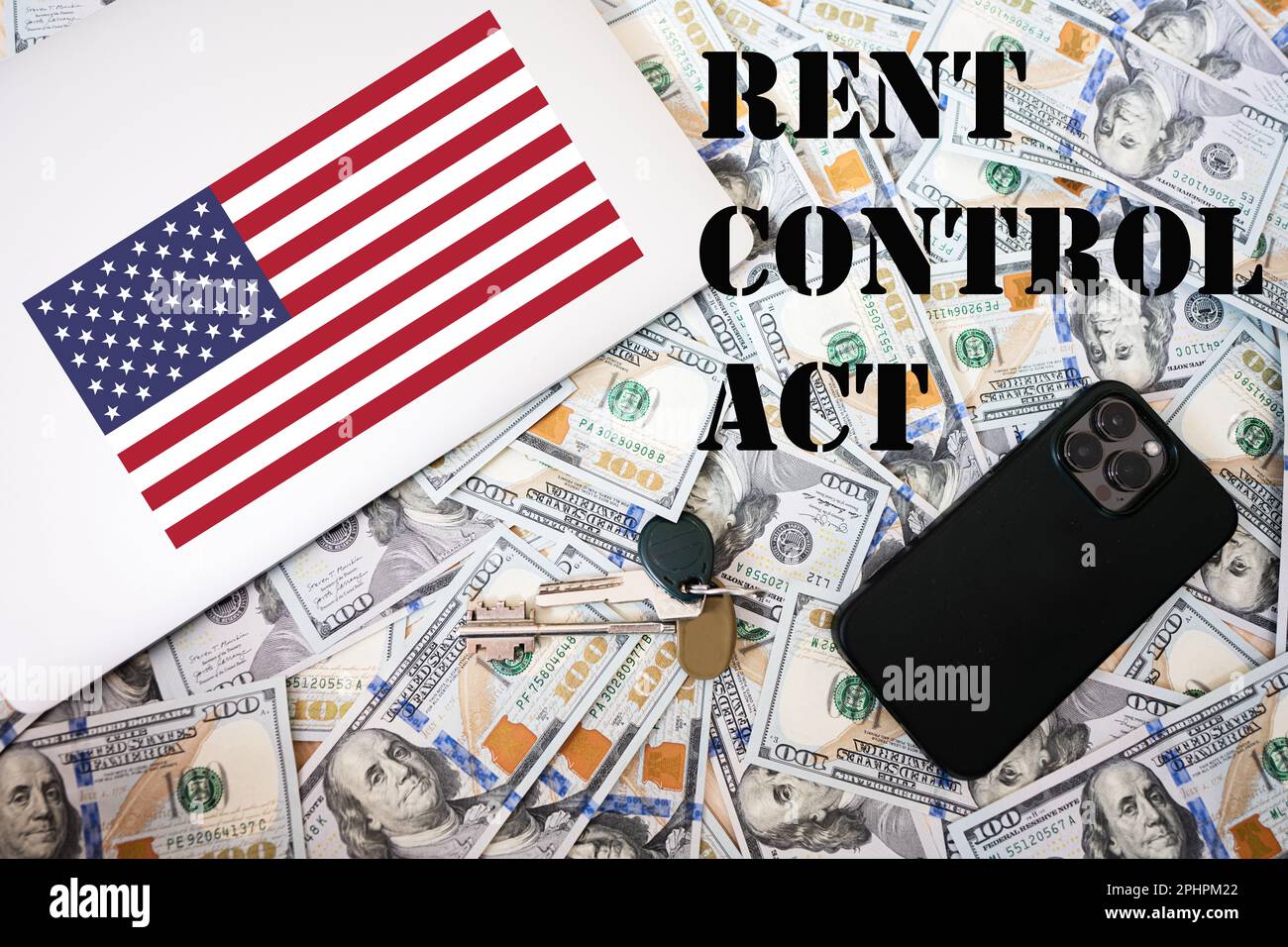 Rent control act concept. USA flag, dollar money with keys, laptop and ...
